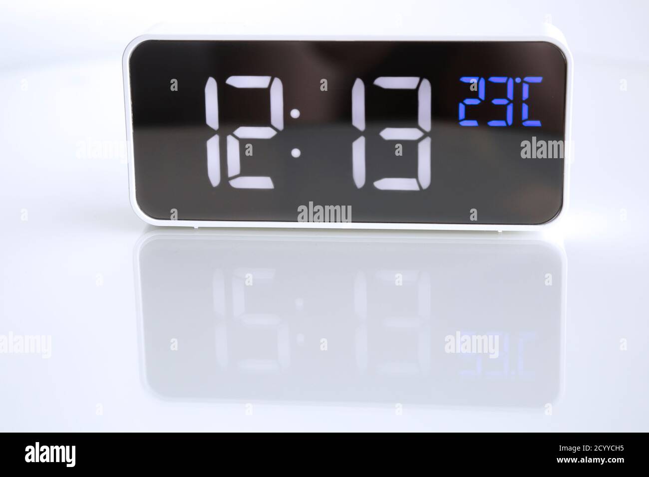 Digital clock showing date and temperature on a white background Stock ...