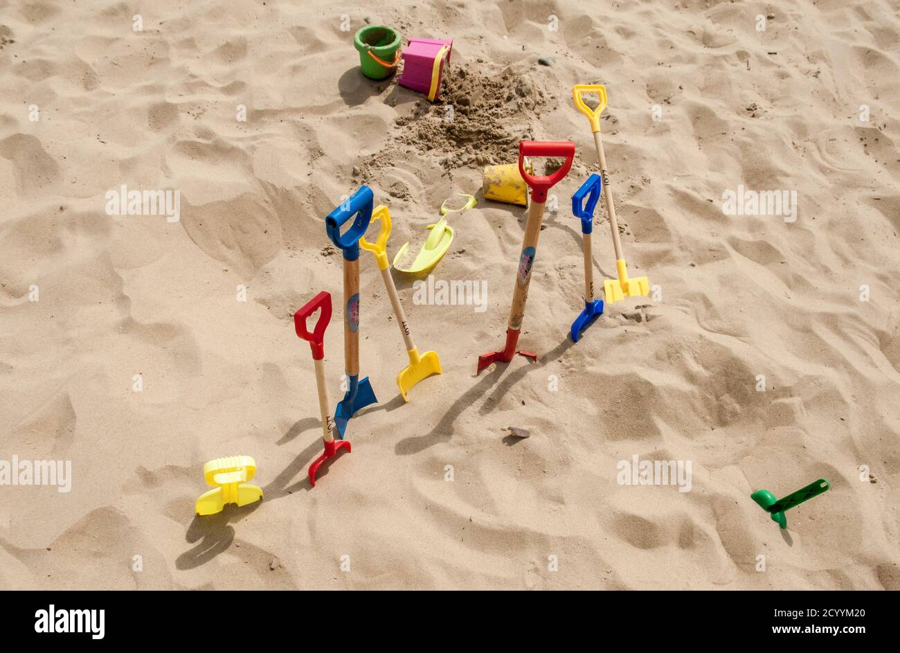 Children’s colourful spades and buckets on the beach at Fisherman’s ...