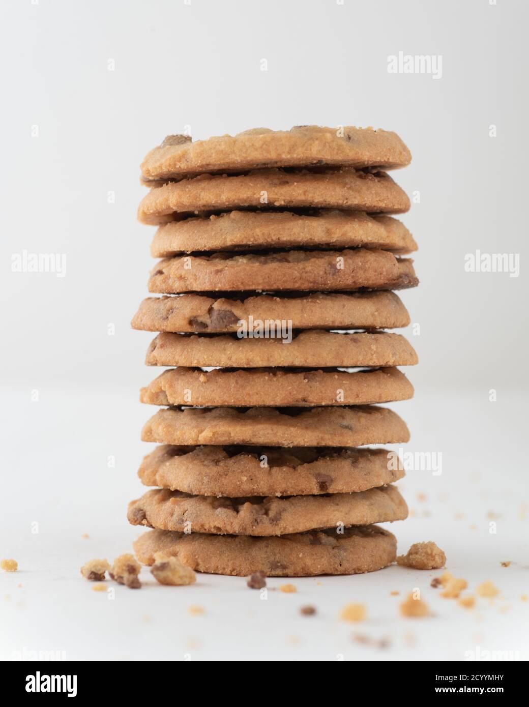 Vertical shot of a stack of chocolate chip cookies isolated on white ...