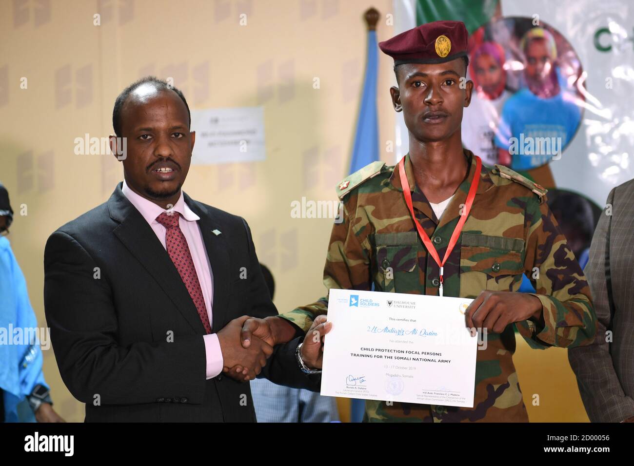 The Somali Federal Minister of Defence, Hassan Ali Mohamed, hands a ...