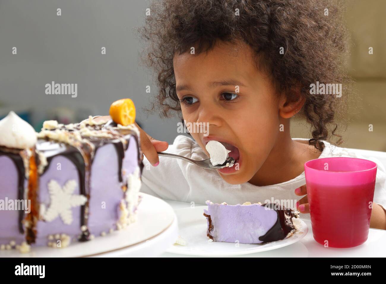 Girl eating cake african hi-res stock photography and images - Alamy