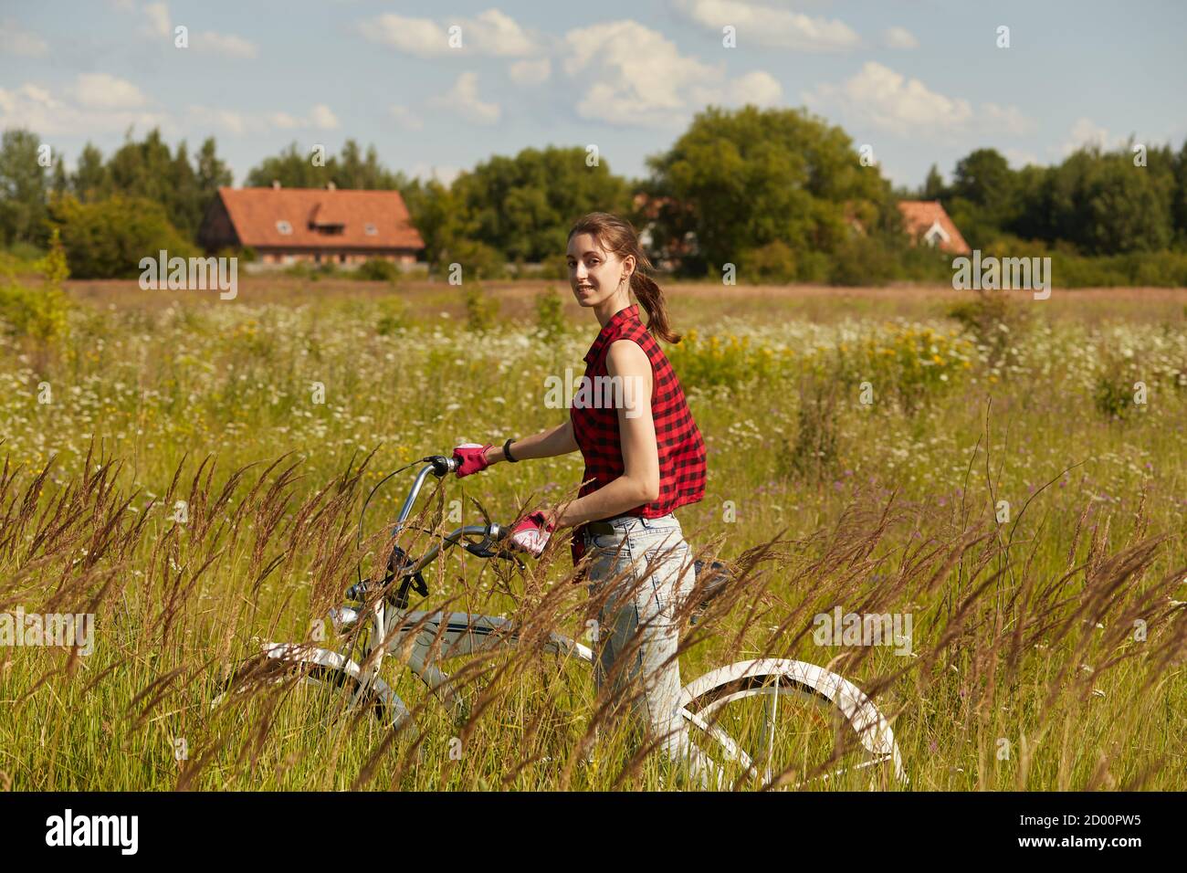 Woman walking with bike hi-res stock photography and images - Alamy