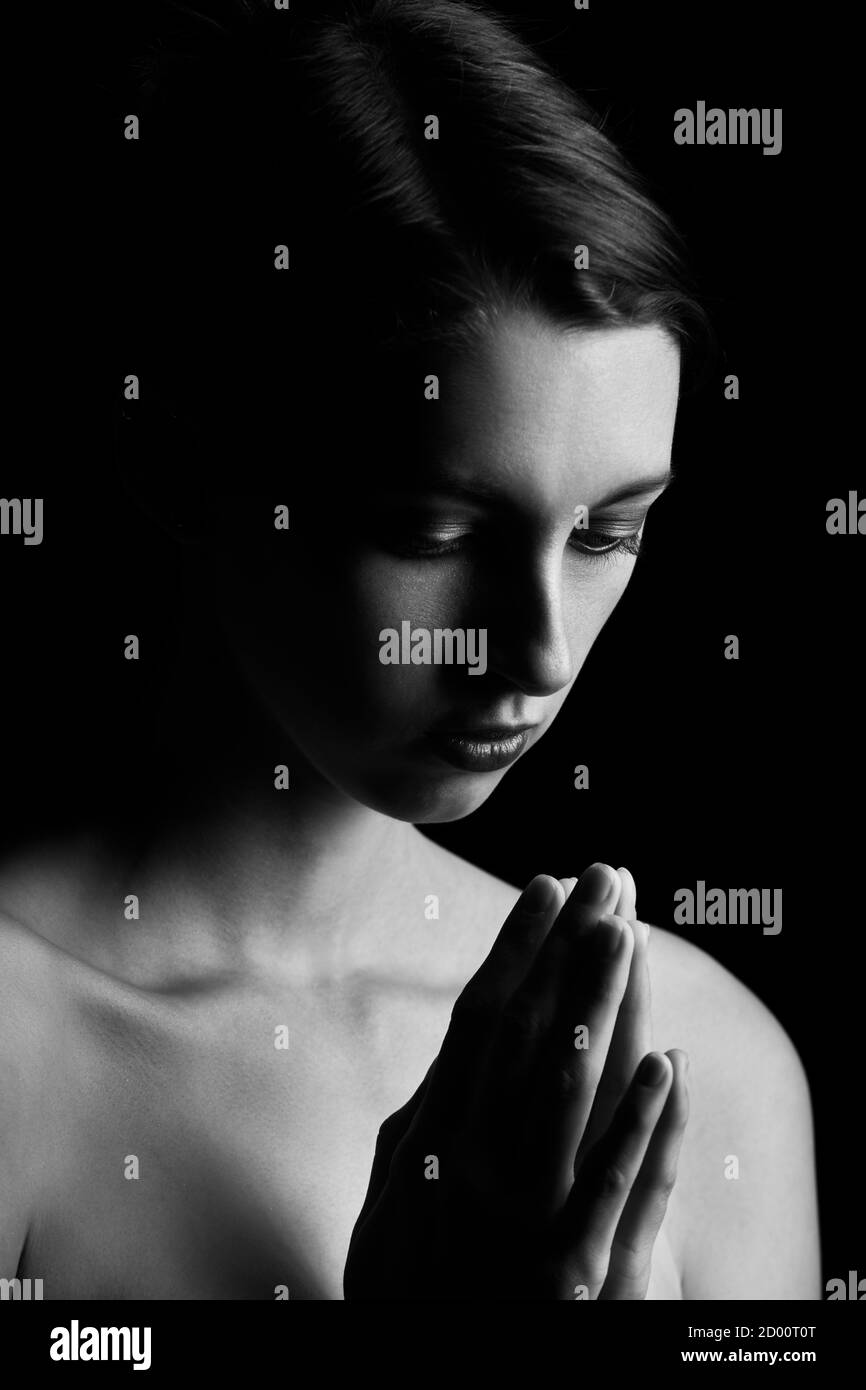 Young sad christian woman praying Black and White Stock Photos & Images ...