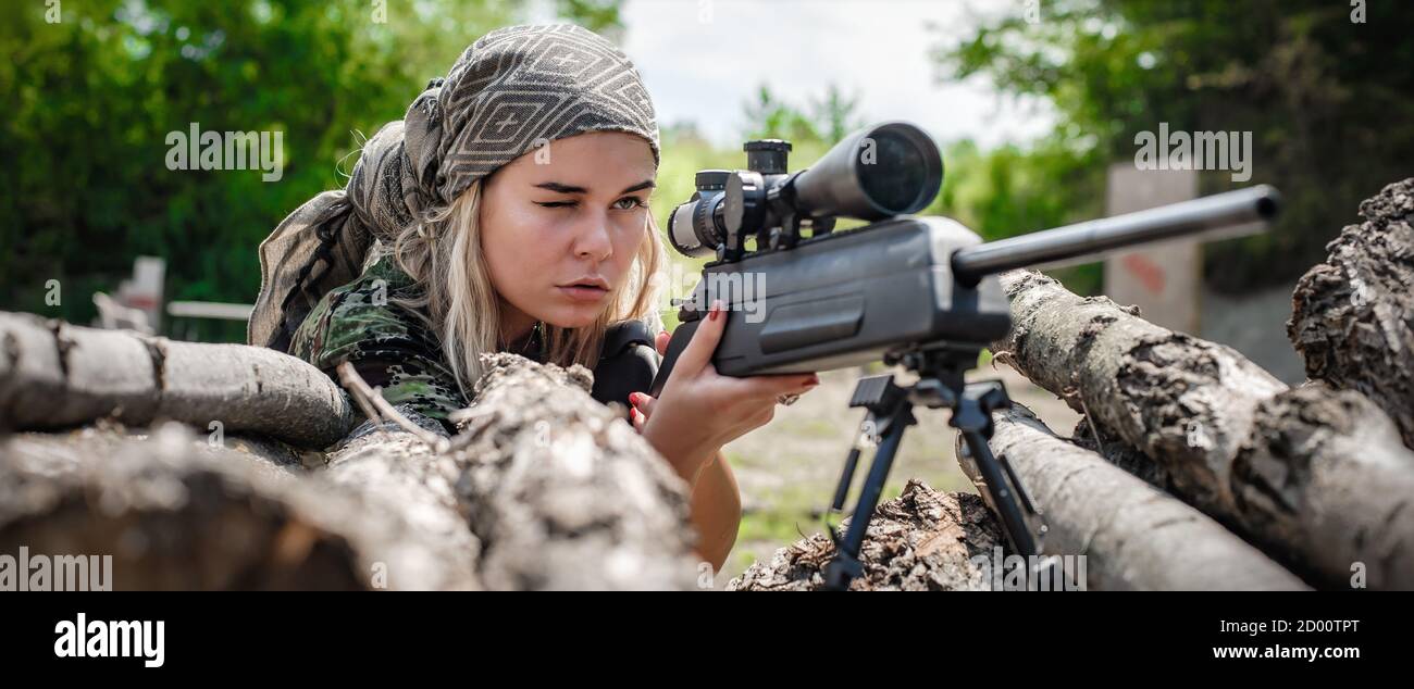 Female soldier shooting with sniper rifle. Woman with weapon. Firearm ...