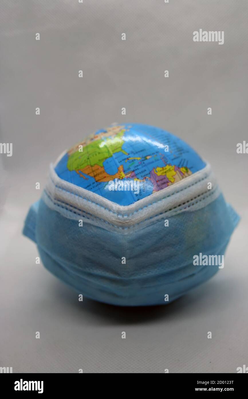 World wearing protective mask. Globe with a surgical mask. Covid ...