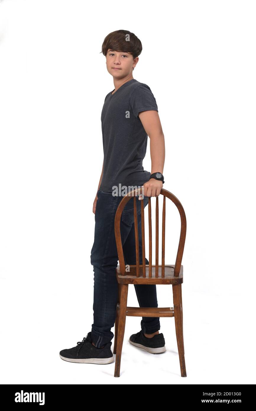 teen boy playing with a chair in white background Stock Photo - Alamy