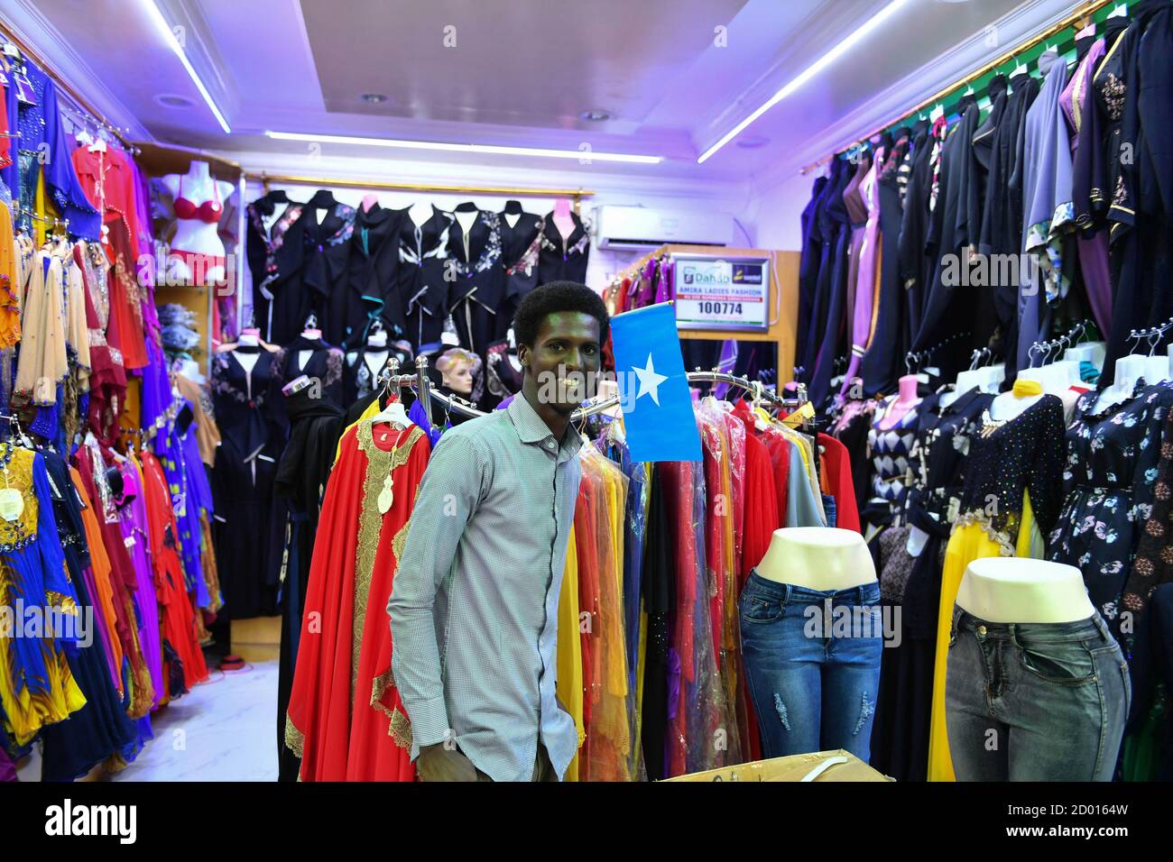 A young man inside a boutique at the posh Mogadishu Mall located in ...