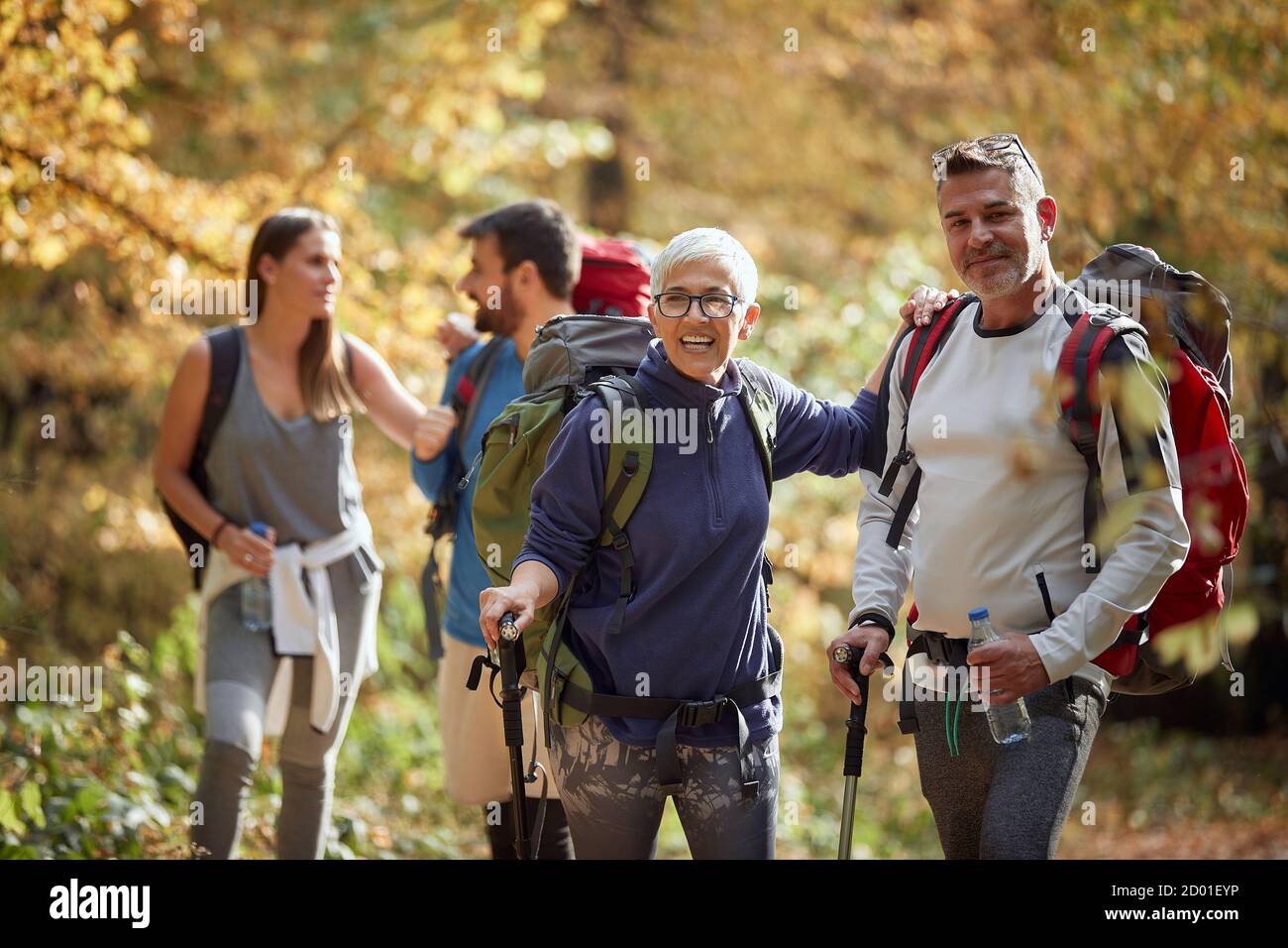 Family trekking in the woods; Quality family time concept Stock Photo ...