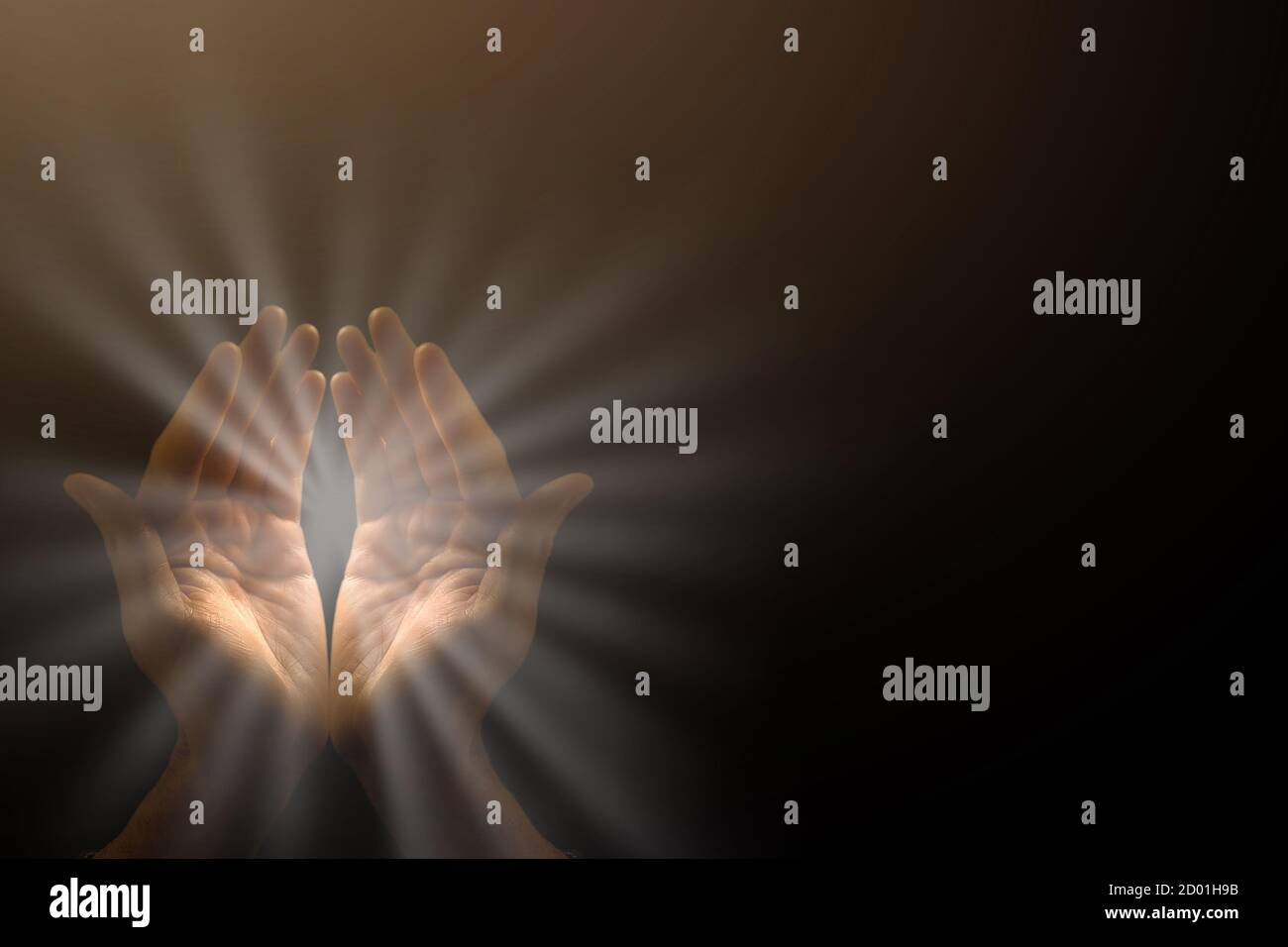 Light in the human hands in the dark Stock Photo - Alamy