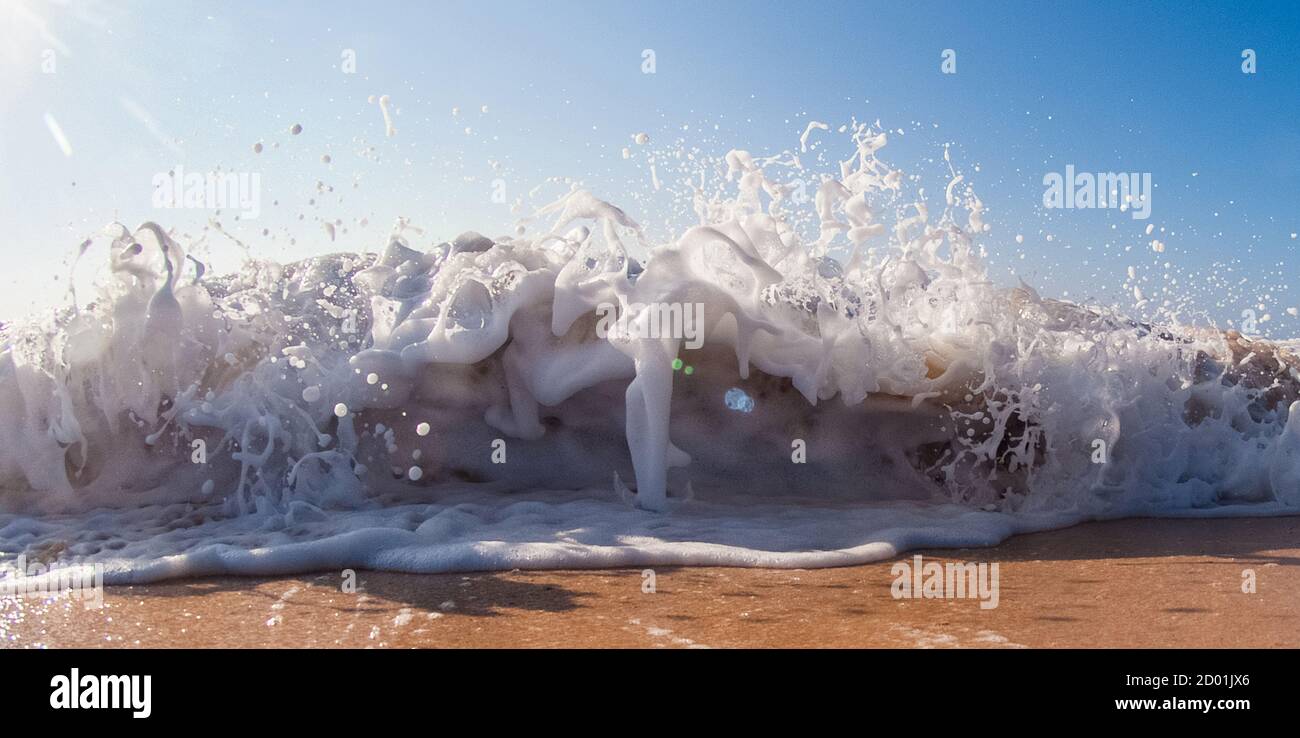 Wave crashing on the beach Stock Photo - Alamy