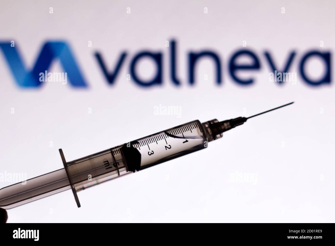 In this photo illustration a medical syringe is seen with Valneva SE ...