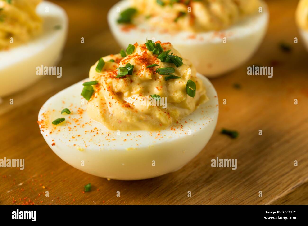 Cooked Organic Hard Boiled Eggs with Chives and Paprika Stock Photo - Alamy