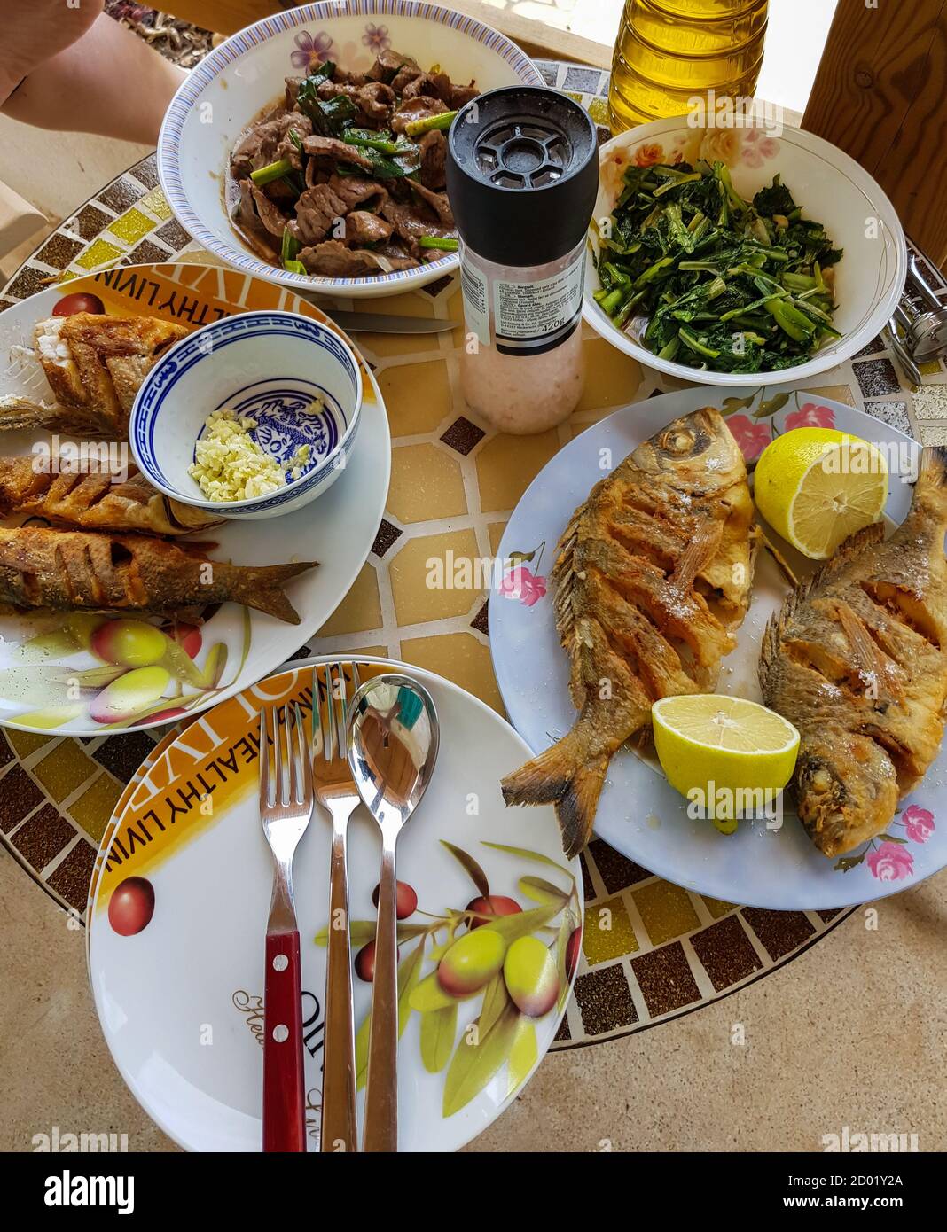 A meal of fried fish, cooked meat and vegetables in the Mediterranean ...