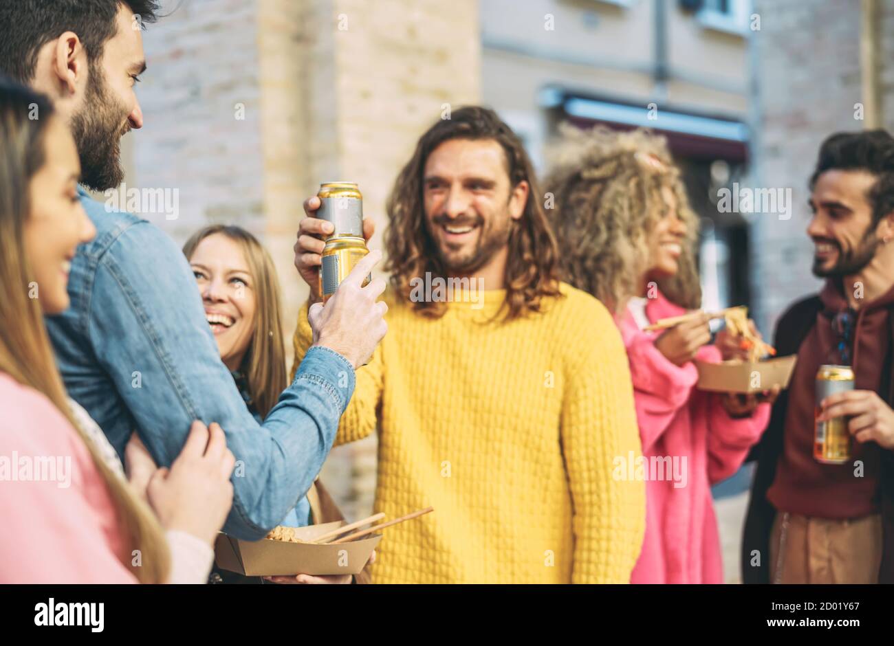 Happy friends eating street food and drinking beers outdoor - Group ...