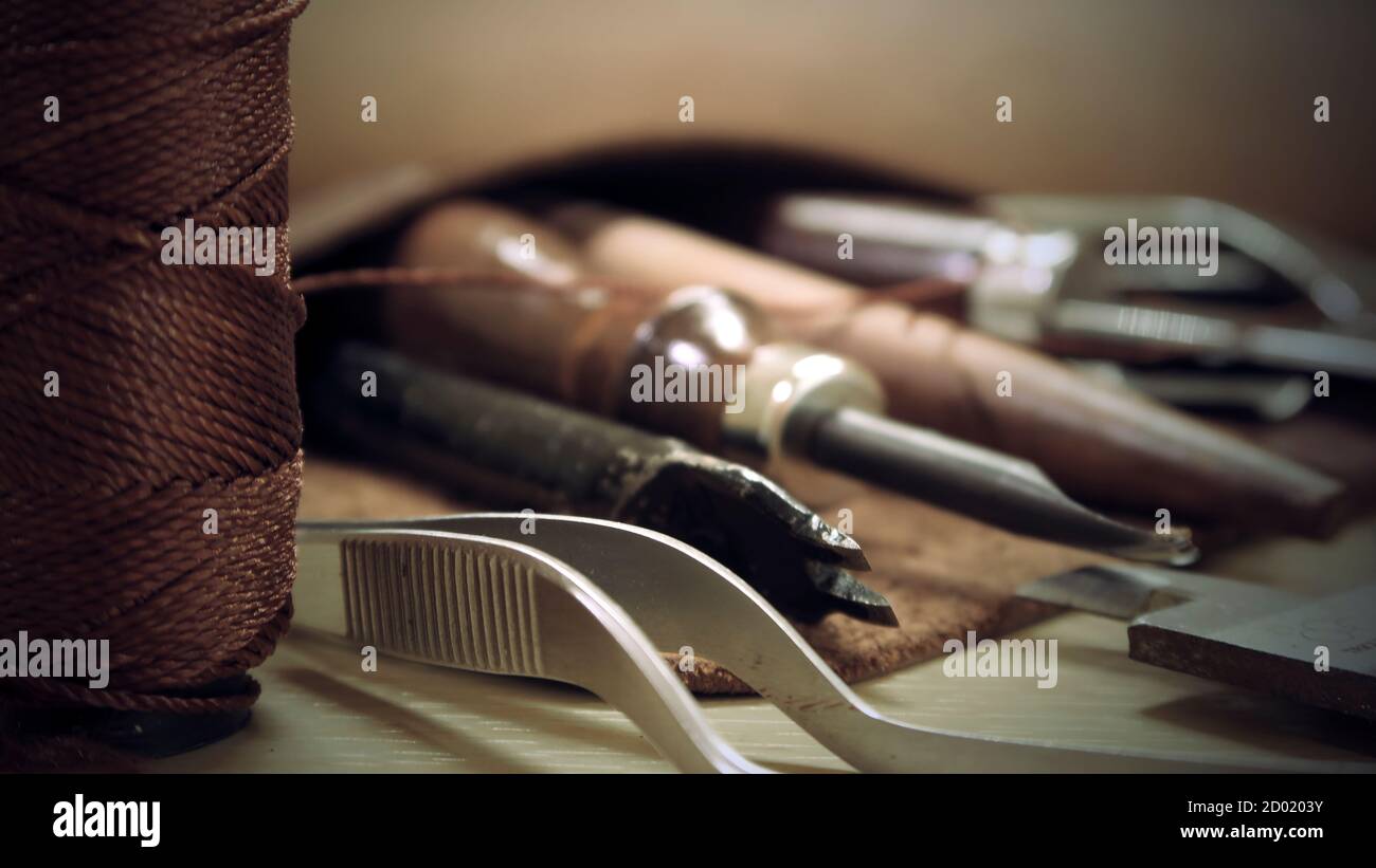 Leather craft tools on a wooden table at traditional workshop Stock ...