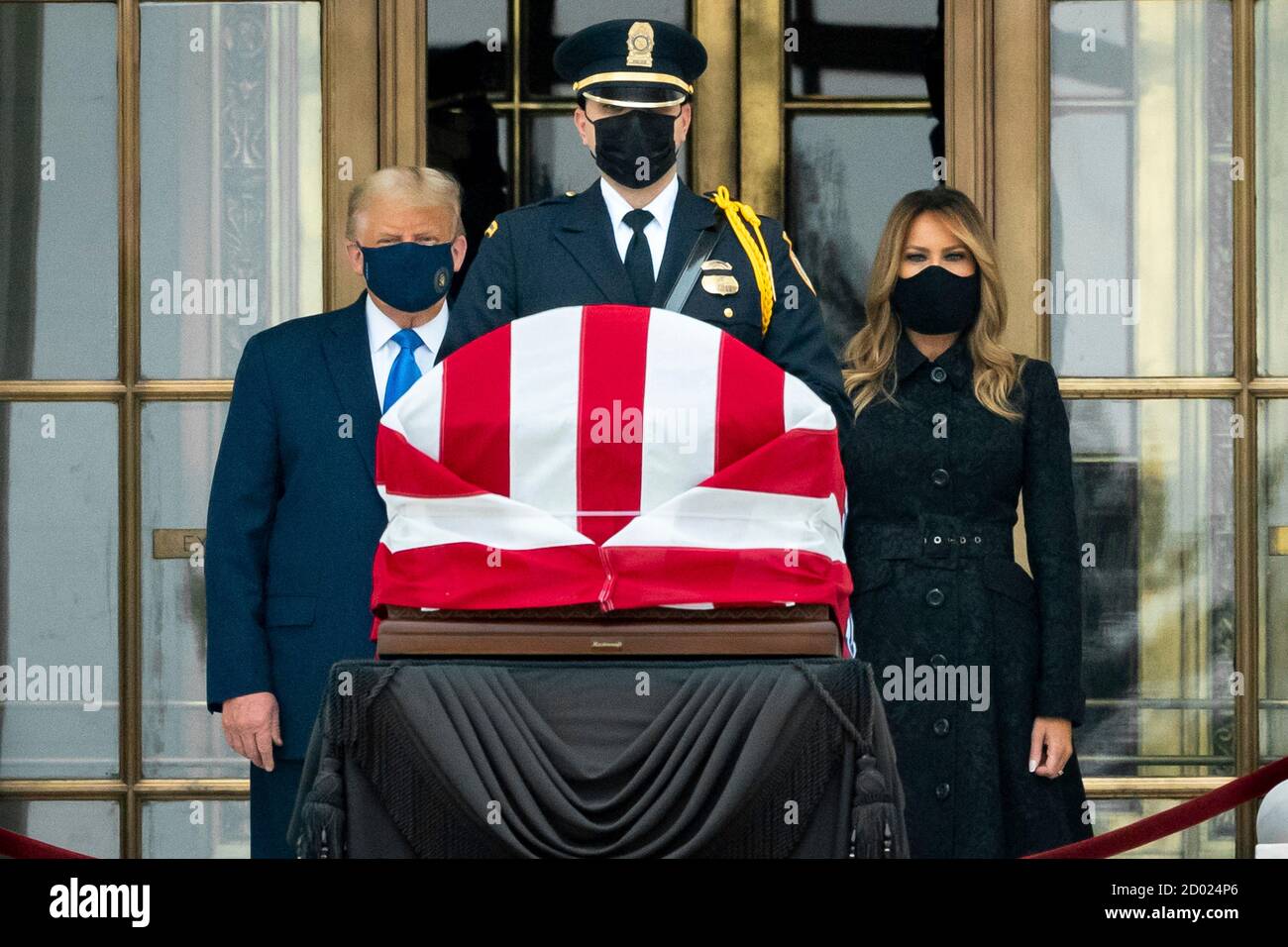 U.S. President Donald Trump and First Lady Melania Trump pay respects ...