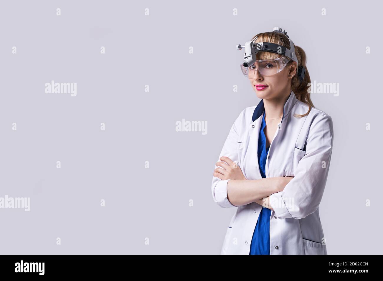 Confident ENT doctor wearing surgical headlight head light and ...