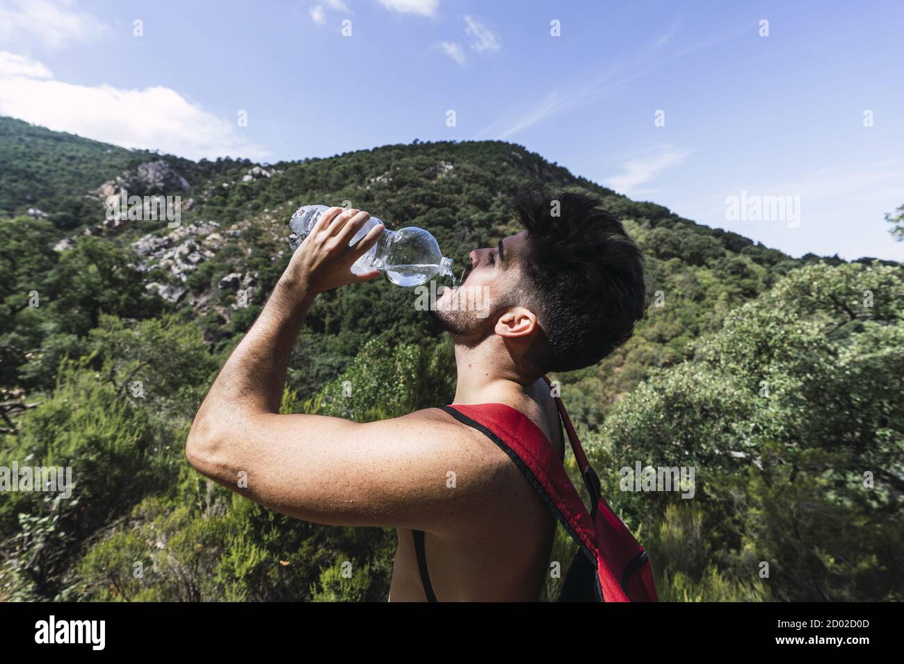 Closeup shot of young male drinking water in nature Stock Photo - Alamy