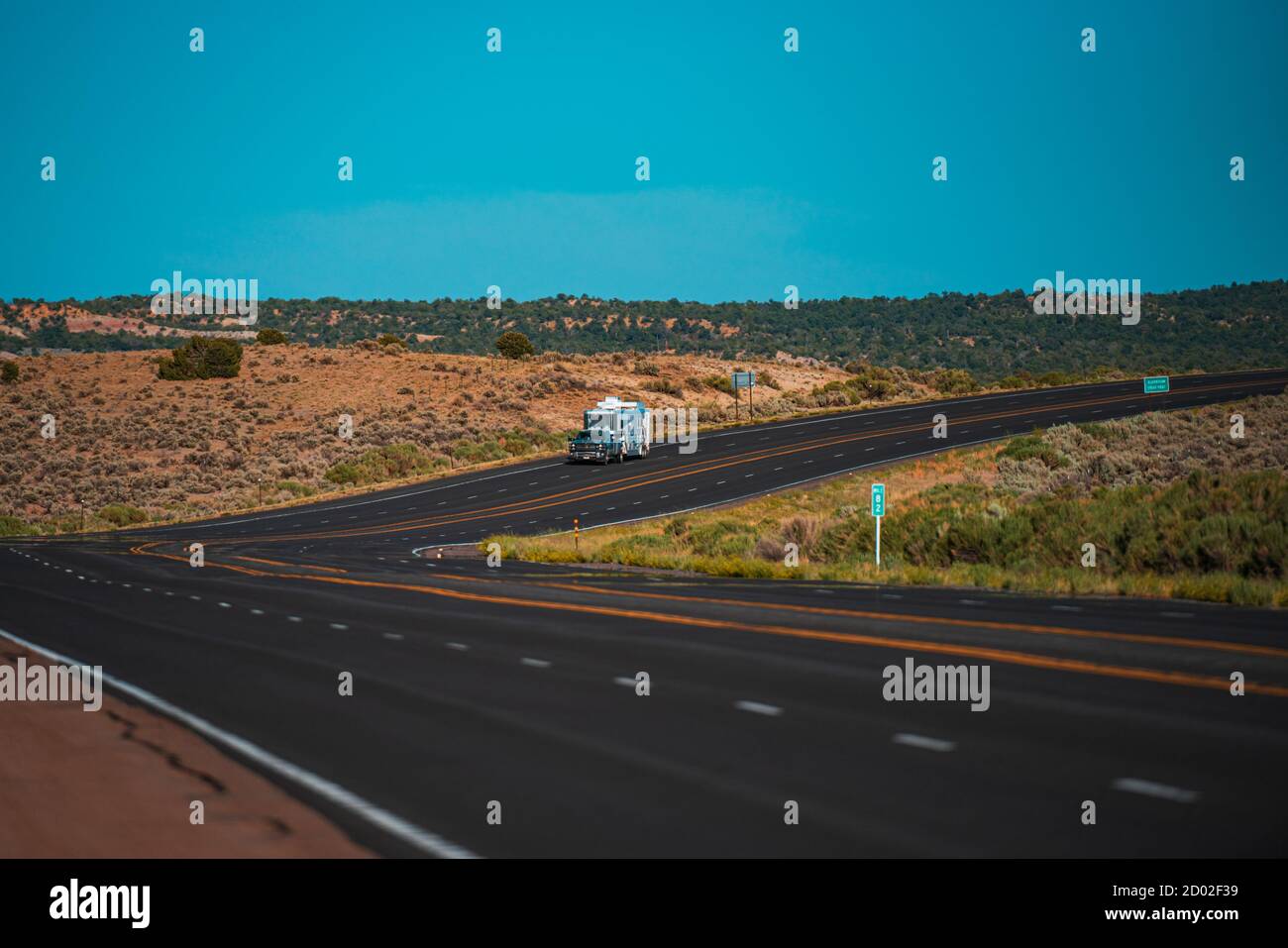 Landscape with rocks, sunny sky with clouds and beautiful asphalt road ...
