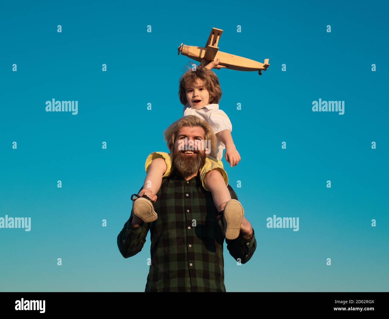 Sweet childhood. Happy father and son with airplane dreams of traveling ...