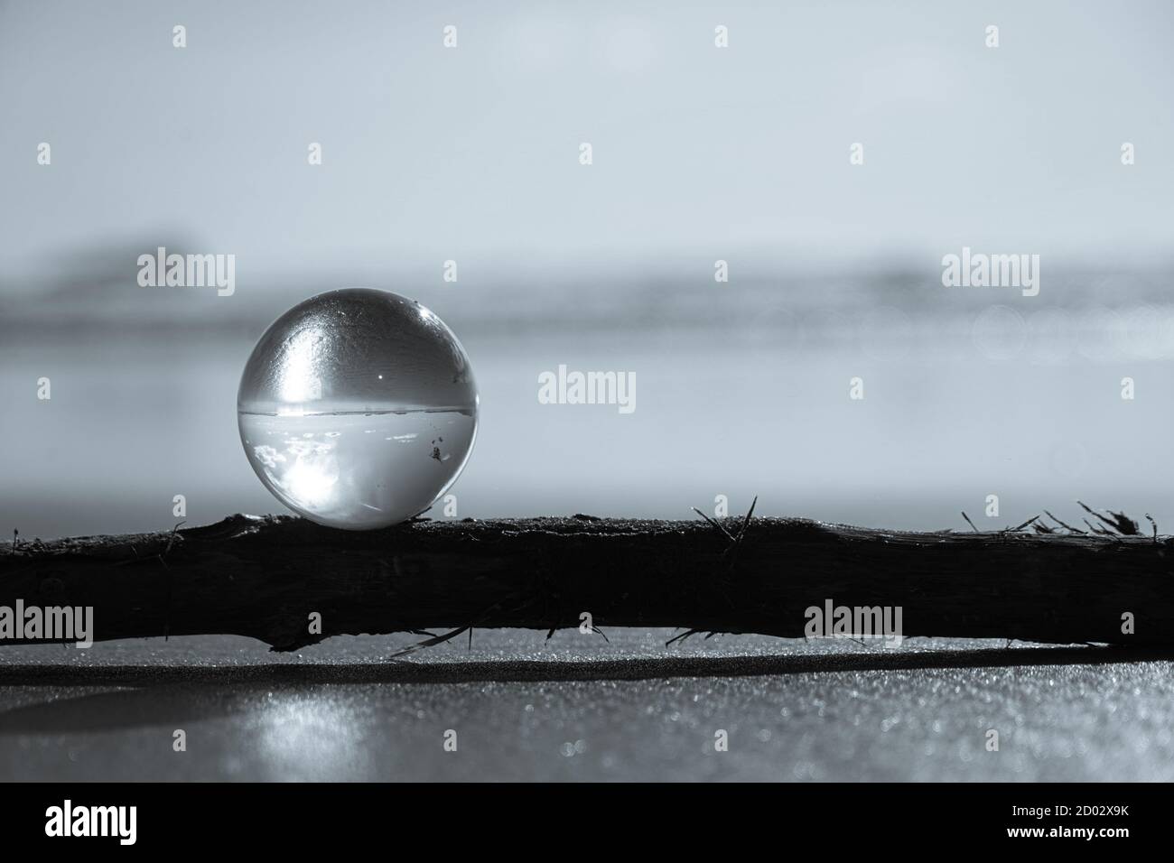 Photography Crystal Photo Ball showing upside down reflection of sky beach and waves balanced on ...