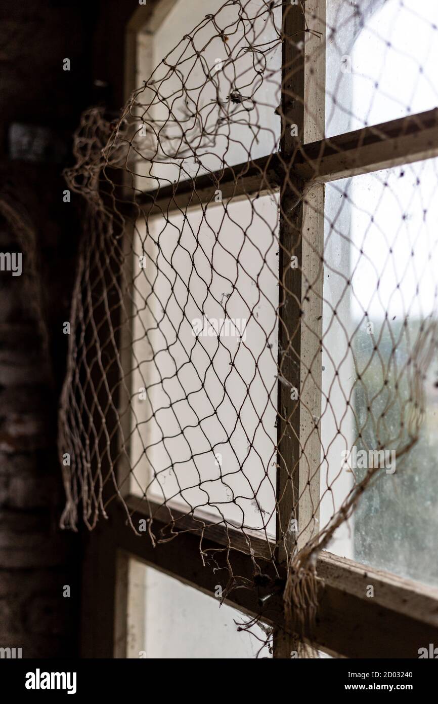 Fishing net on the window Stock Photo - Alamy
