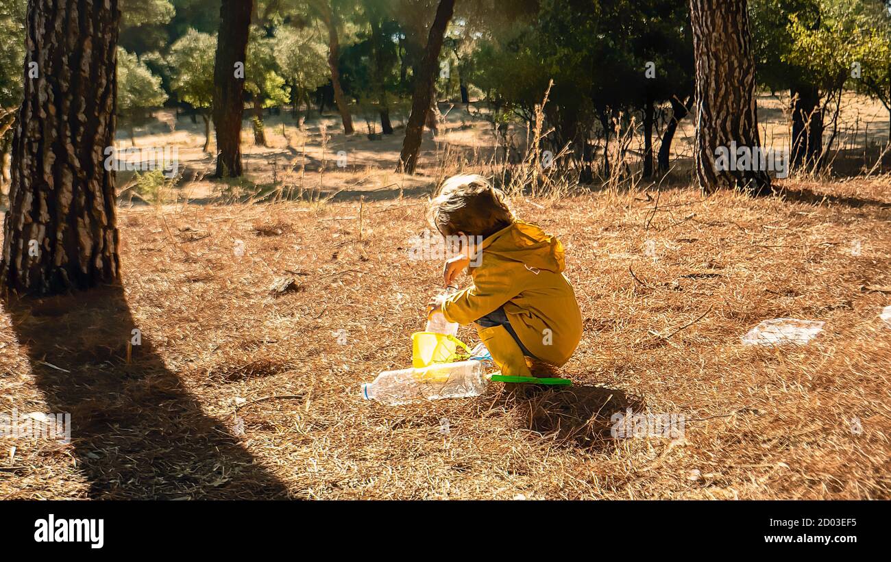 Child picking up garbage in park hi-res stock photography and images ...
