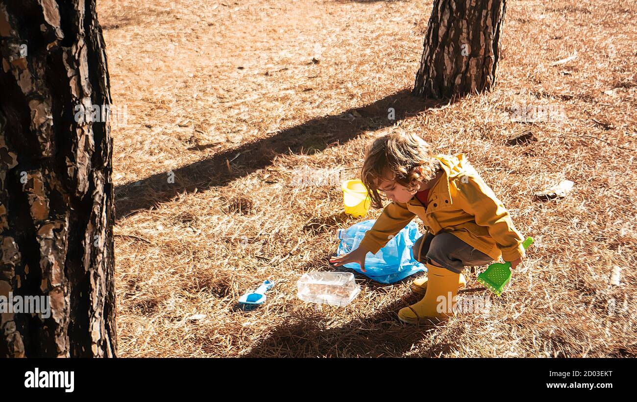 Child picking up garbage in park hi-res stock photography and images ...