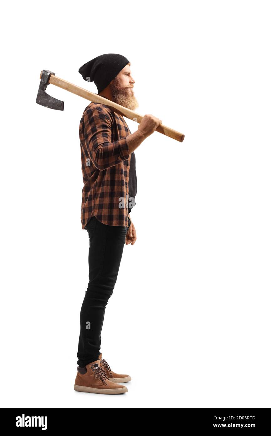 Full length profile shot of a young bearded man holding a hatchet on ...