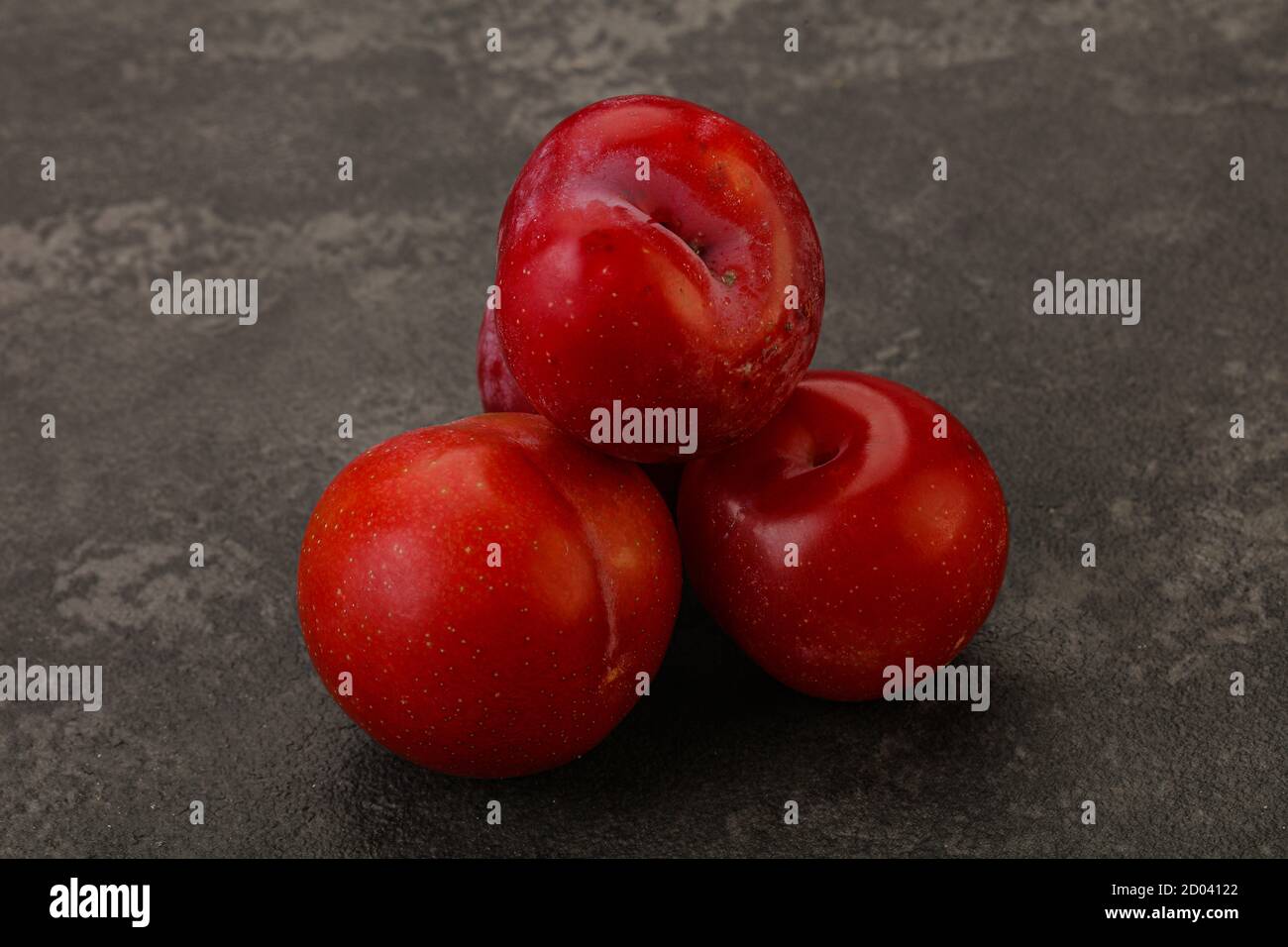 Ripe sweet tasty red plum heap Stock Photo - Alamy