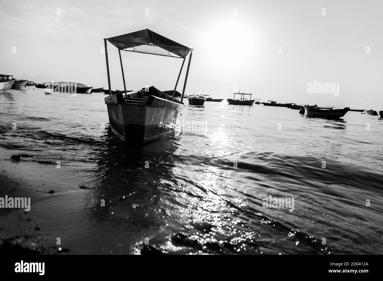 Grayscale shot of a boat on a port Stock Photo - Alamy