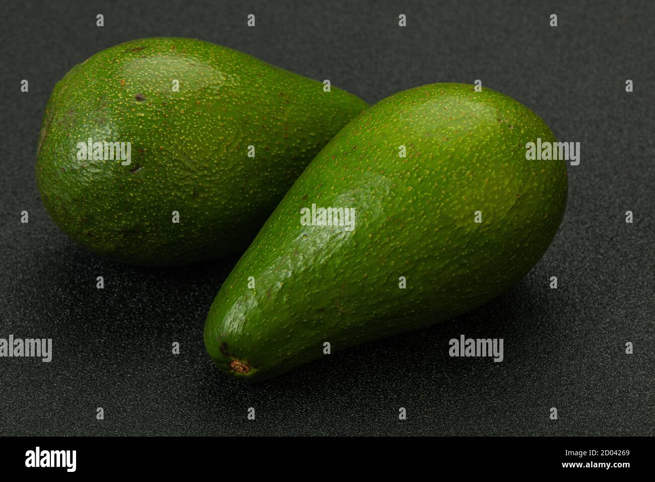 Two ripe exotic green avocado vegetable Stock Photo - Alamy