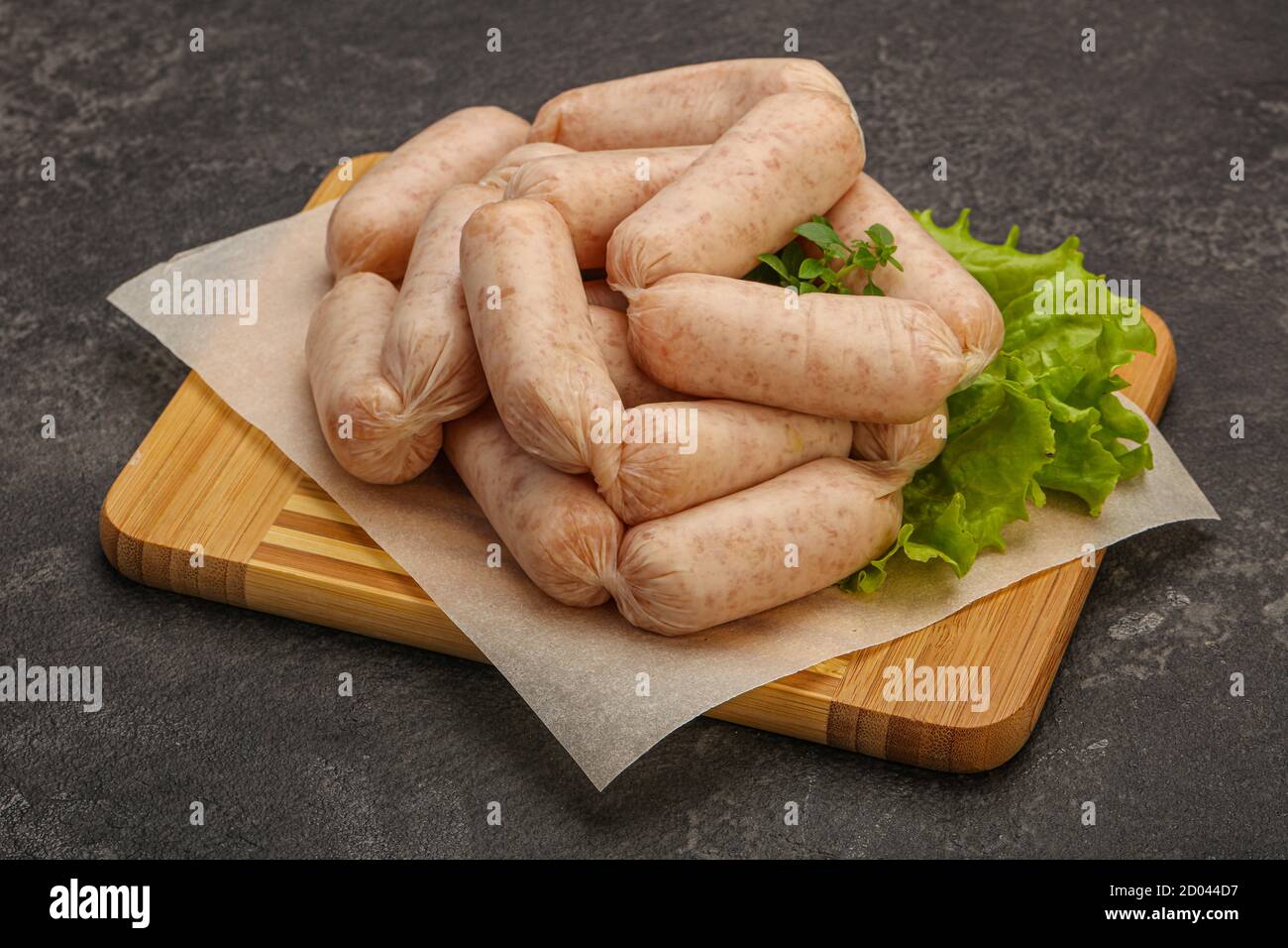 Raw natural chicken baby sausages for roast Stock Photo - Alamy