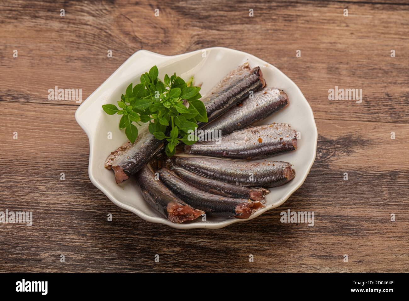 Anchovies fish snack in the bowl served basil leaves Stock Photo - Alamy