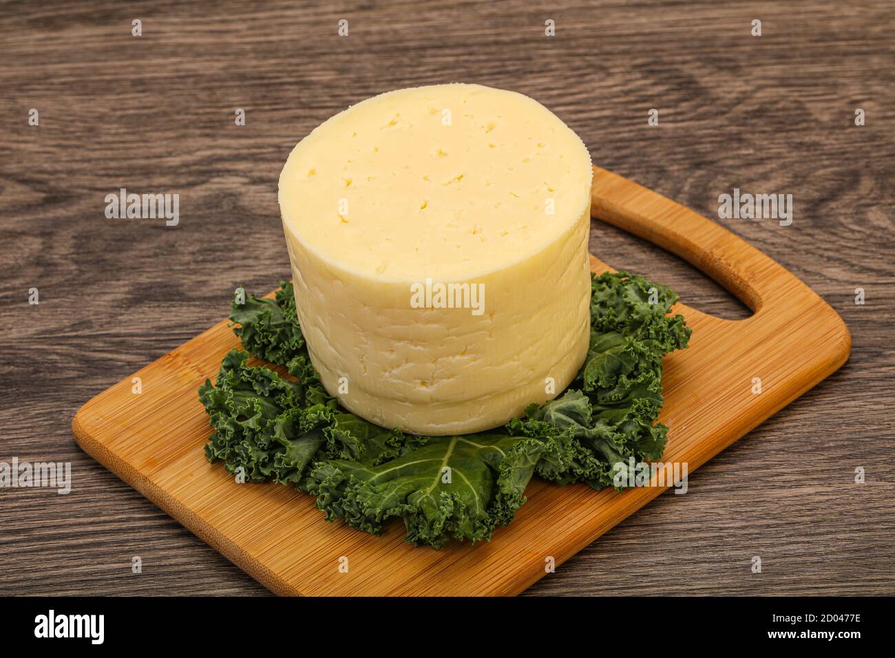 Yellow round dairy soft cheese piece Stock Photo - Alamy