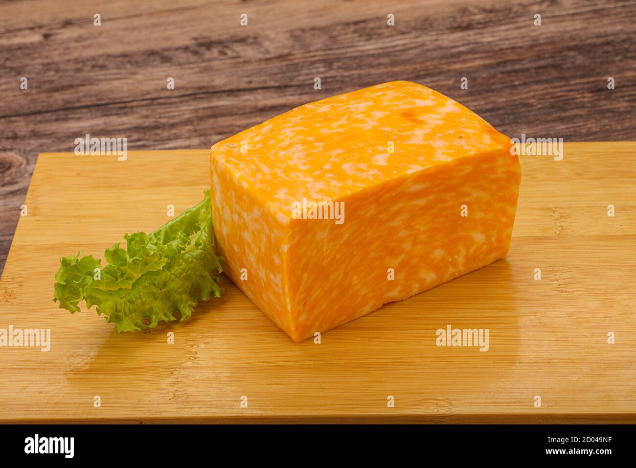 Dairy Marble cheese brick over board Stock Photo - Alamy