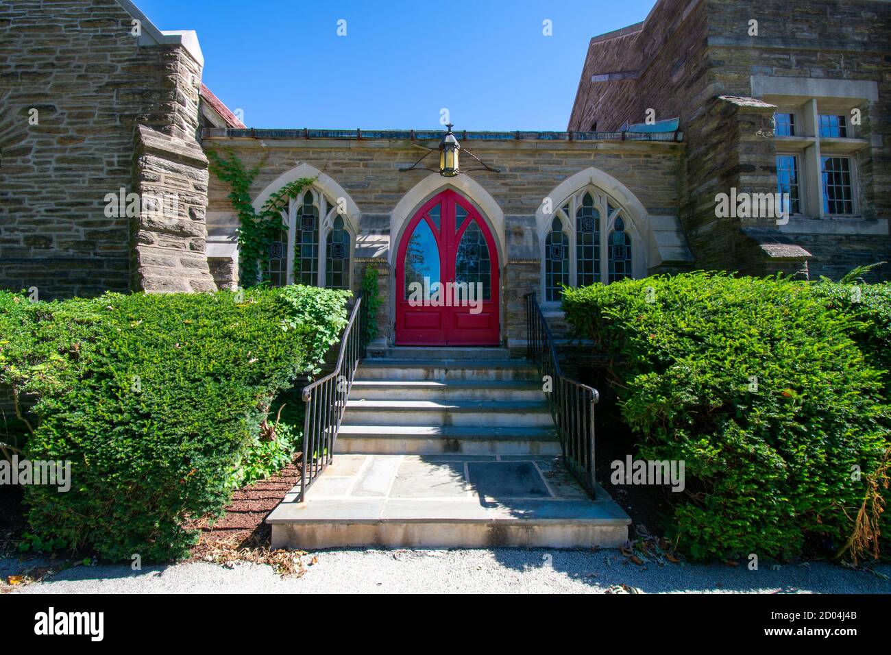 Steps Leading Up to a Red Door on a Cobblestone Church With Trimmed ...