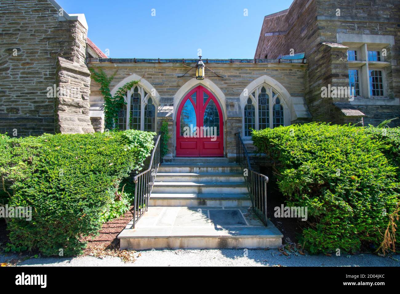 Steps Leading Up to a Red Door on a Cobblestone Church With Trimmed ...