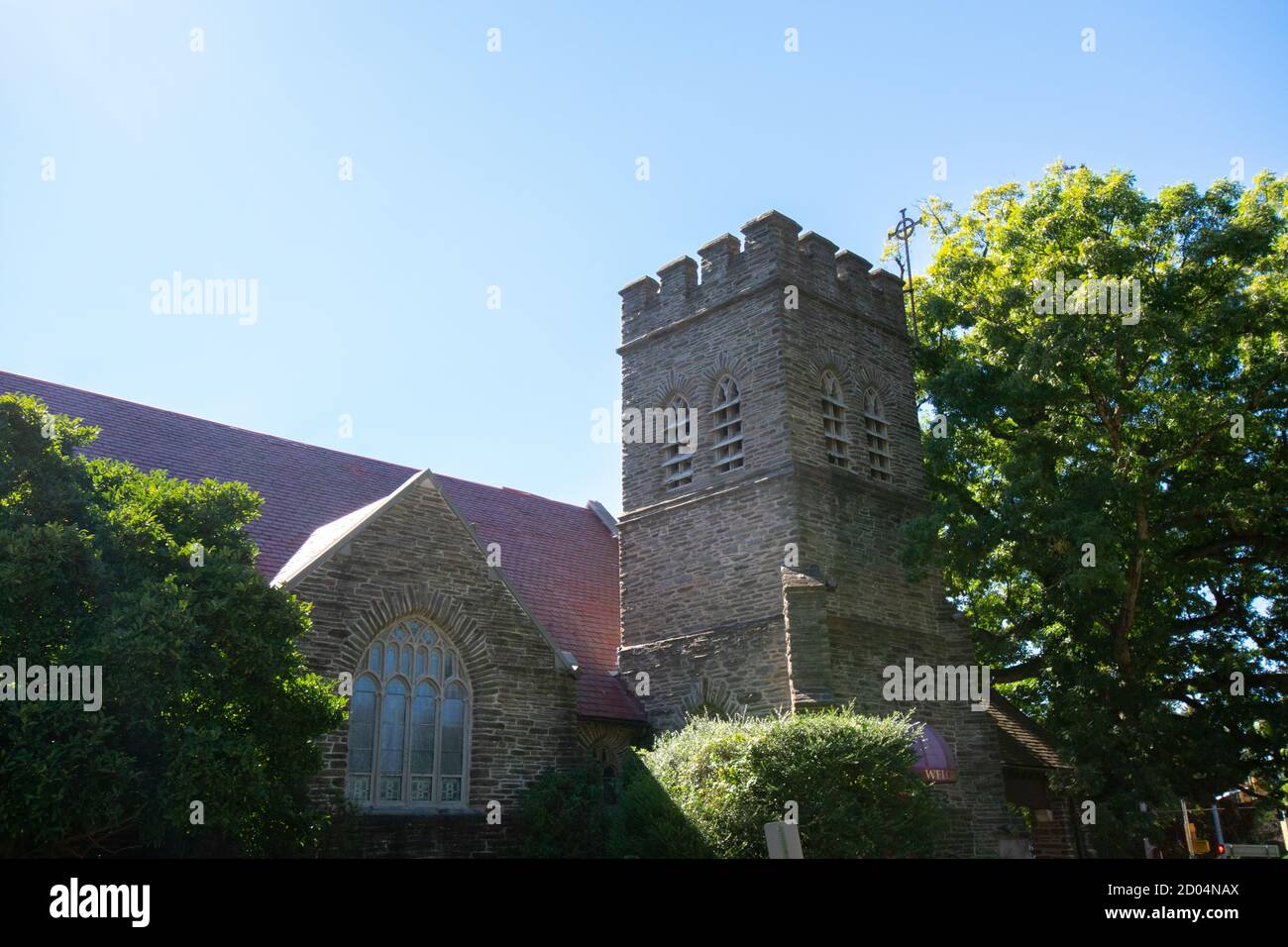 A Large Tower and Window on a Cobblestone Church in Suburban ...