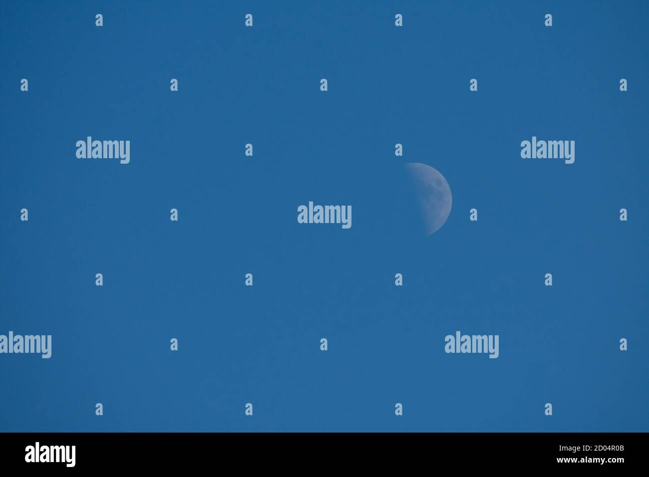 A Dull and Faded Moon on a Clear Blue Sky Stock Photo - Alamy