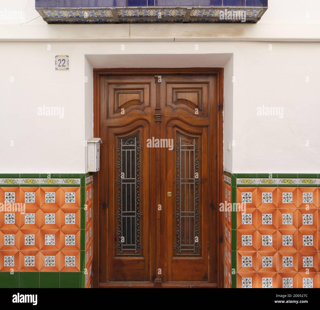 luxurious wooden door with ceramic tiles on the sides called azulejos ...