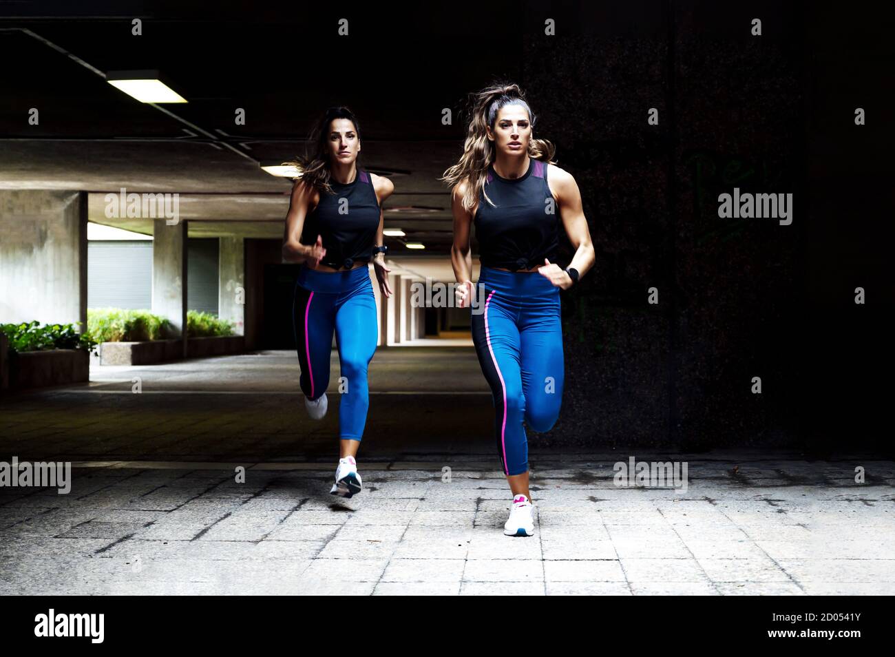 Sporty sisters running during the outdoors workout Stock Photo - Alamy