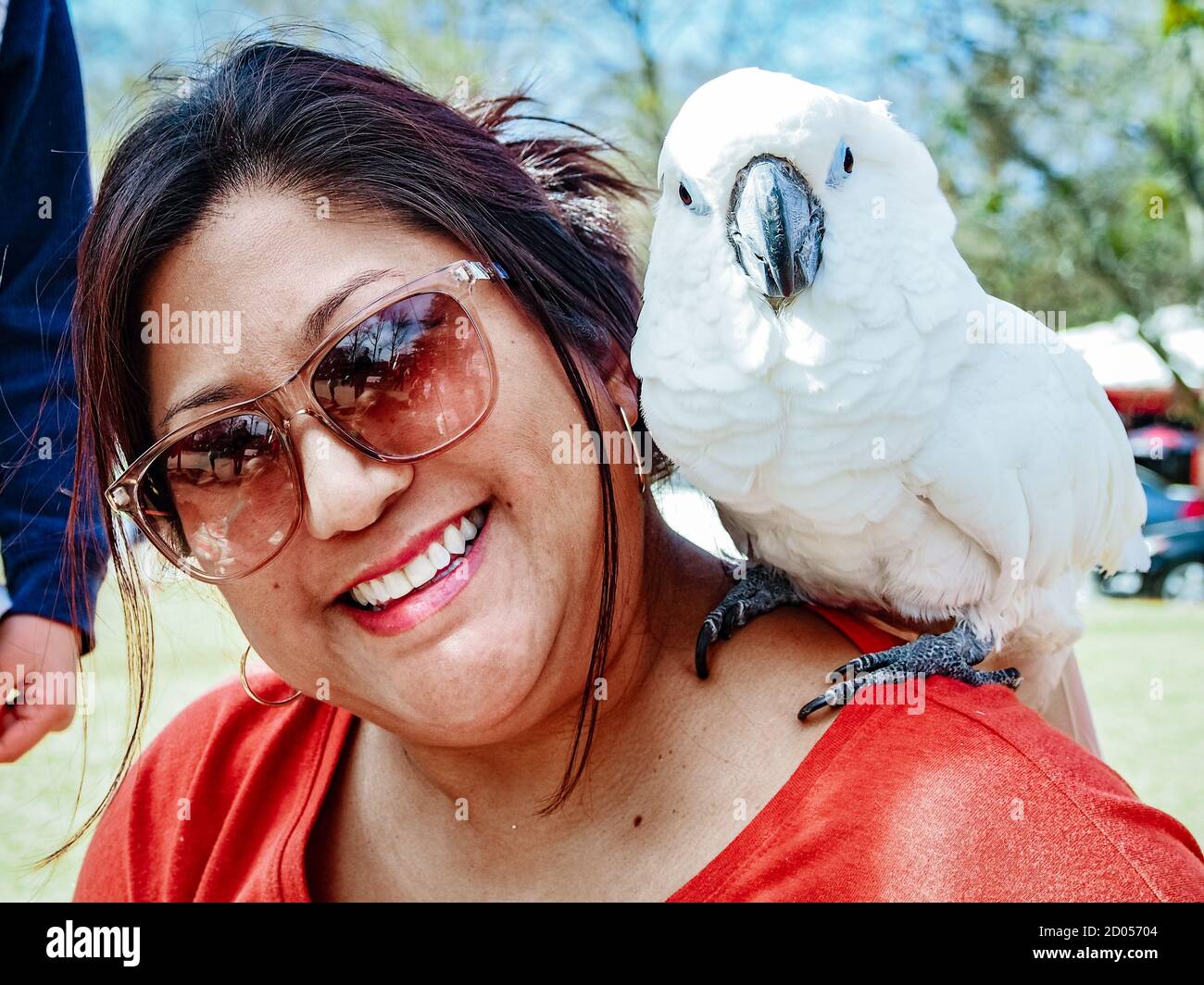 White cockatoo and southeast asian woman posing for a photo Stock Photo ...