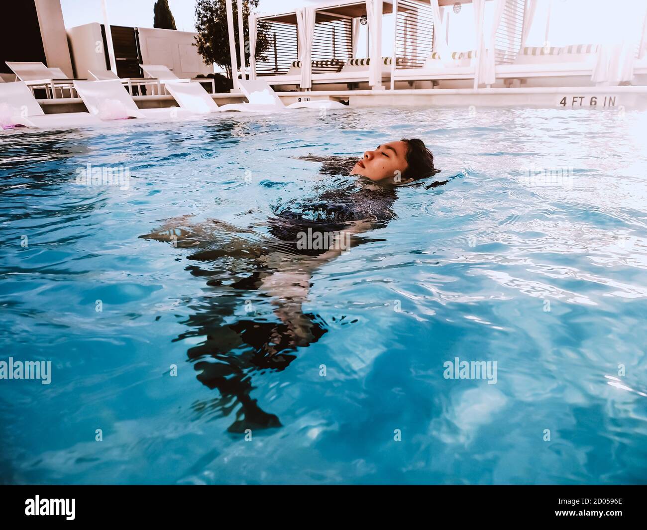 Teenager floats in pool hi-res stock photography and images - Alamy
