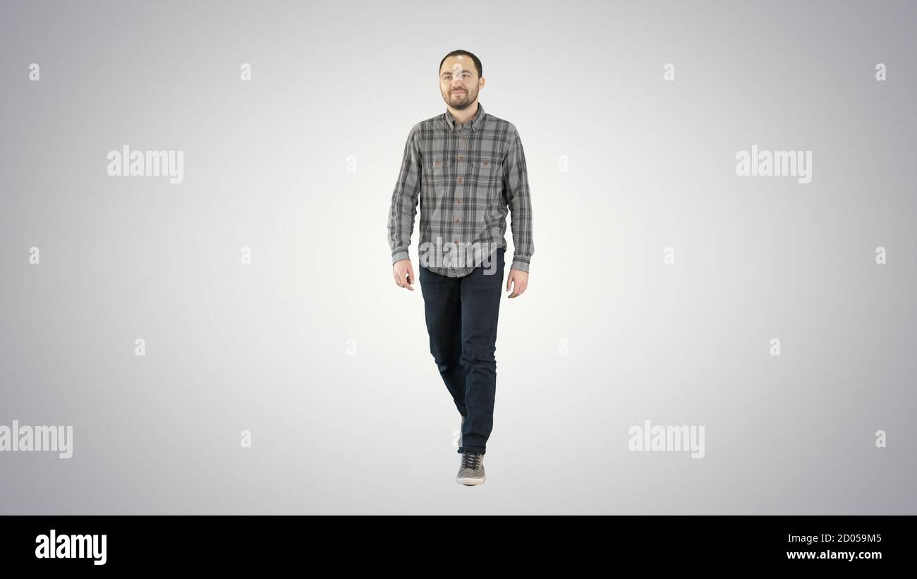Young man walking in a good mood on gradient background Stock Photo - Alamy