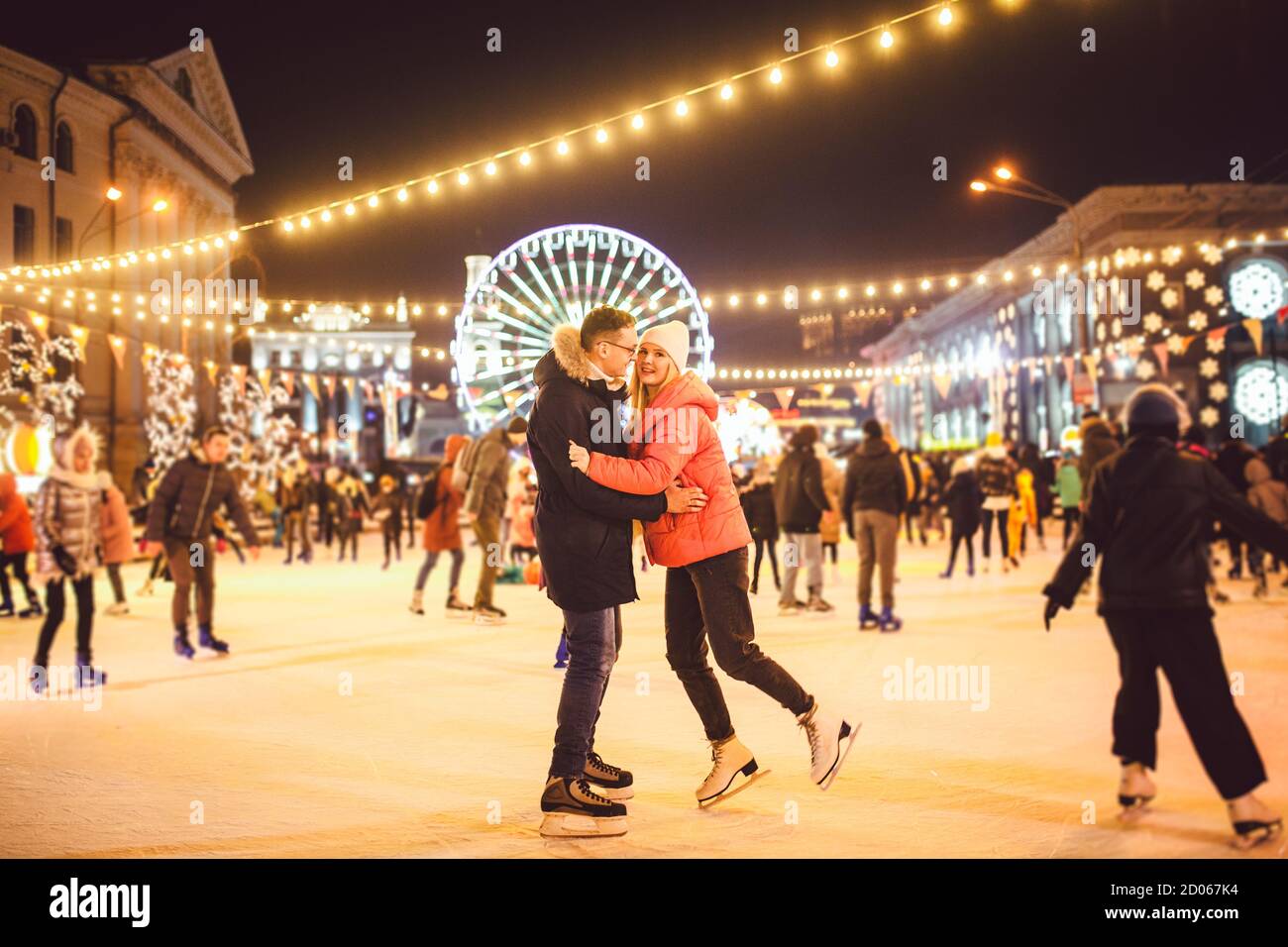 Ice skating together. Romantic winter vacation in ice arena. Young ...