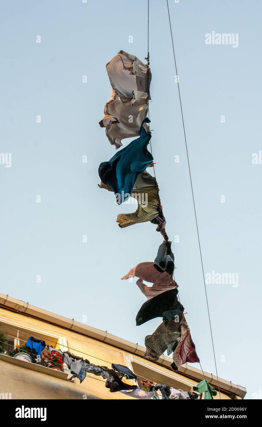 Vertical low angle shot of clothes hanging on a rope Stock Photo - Alamy