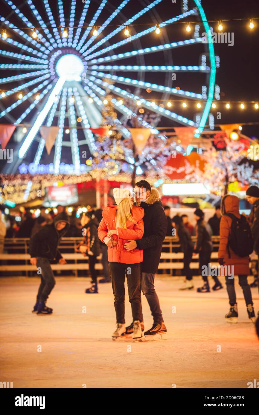 Ice skating together. Romantic winter vacation in ice arena. Young ...