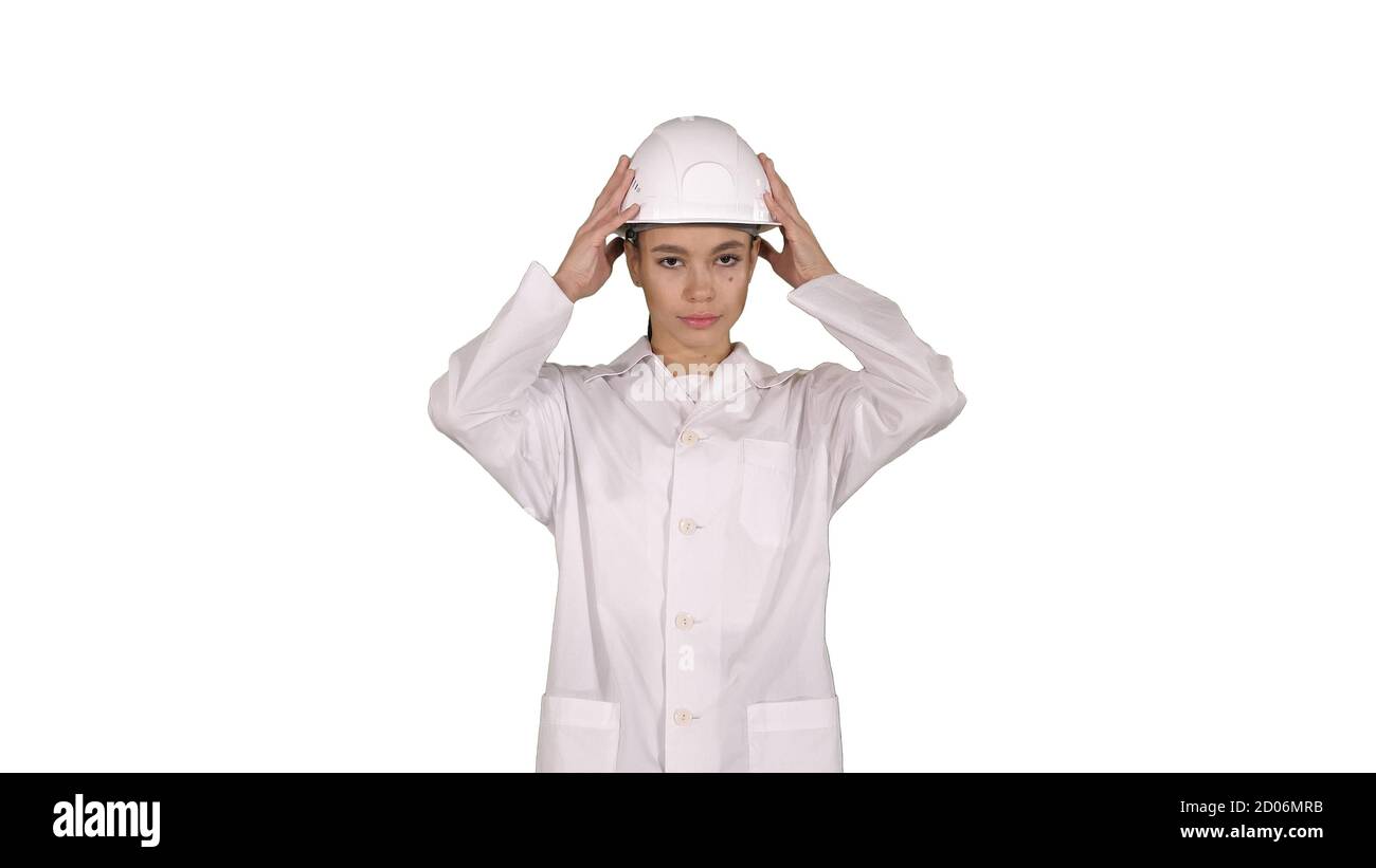 Woman engineer in white robe and white hard hat walking on white Stock ...