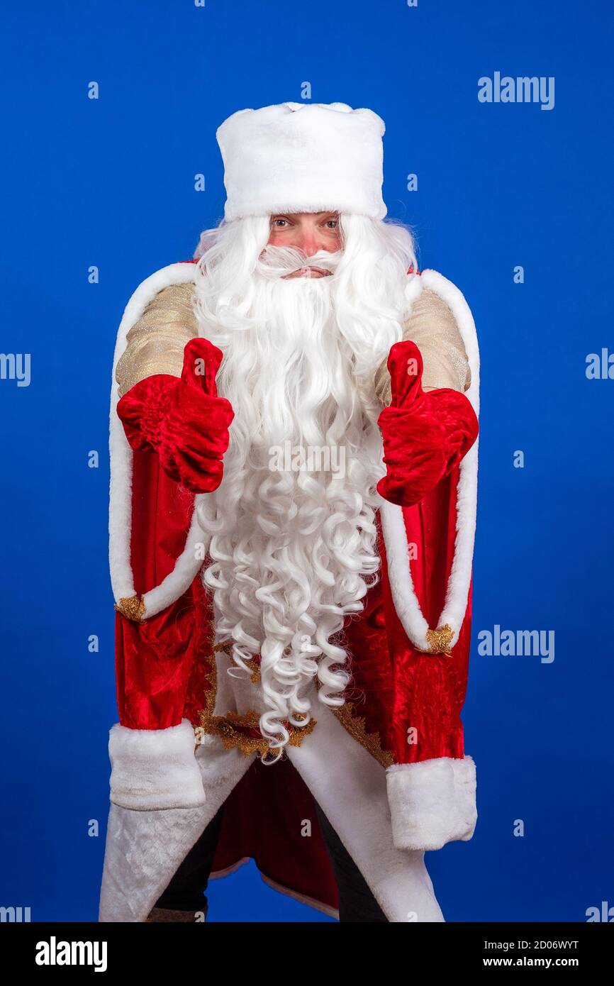 Emotional Santa Claus with a long white beard in a red coat and white ...